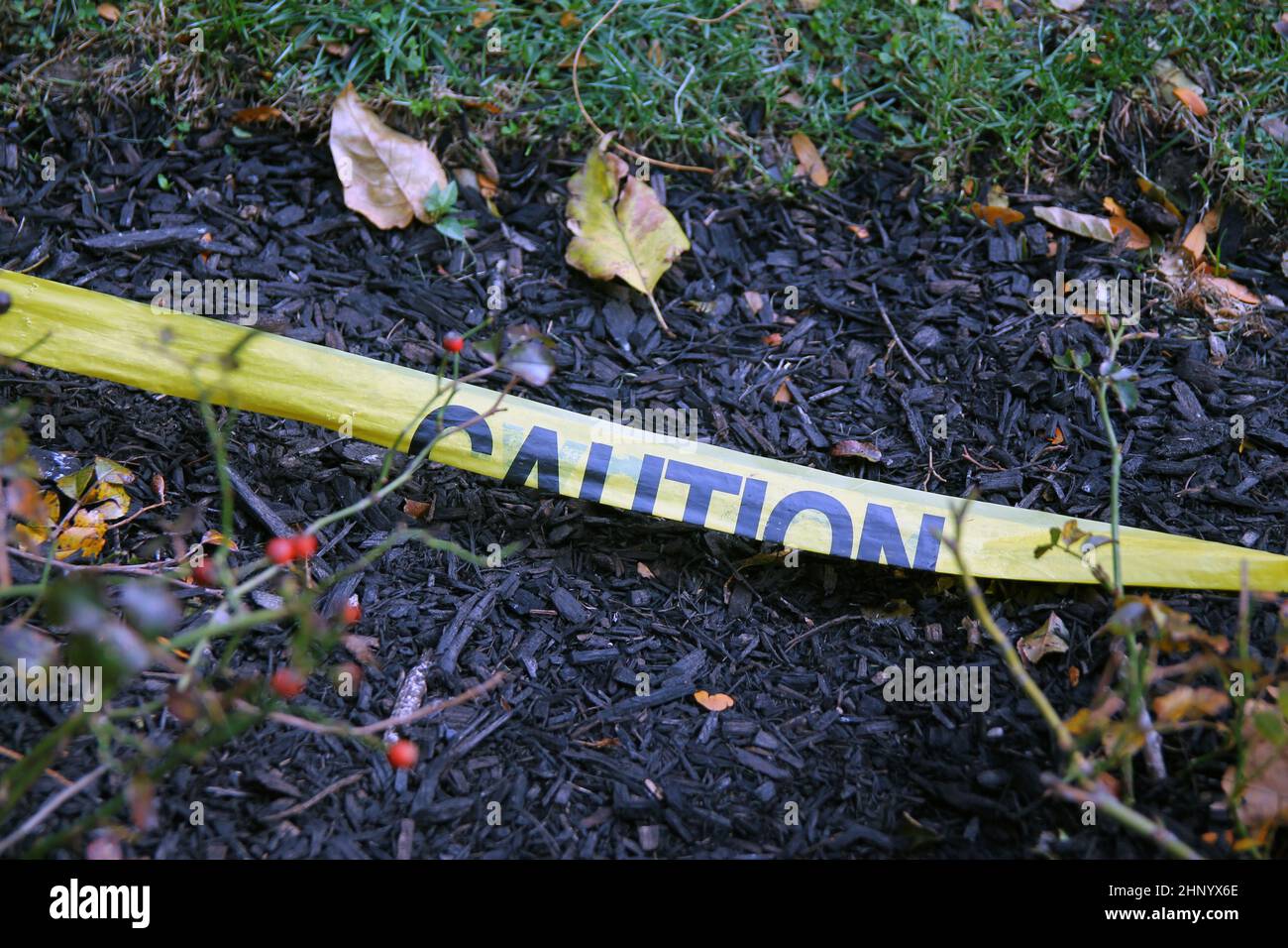 The yellow Caution tape laying on the ground with the soil and the ...