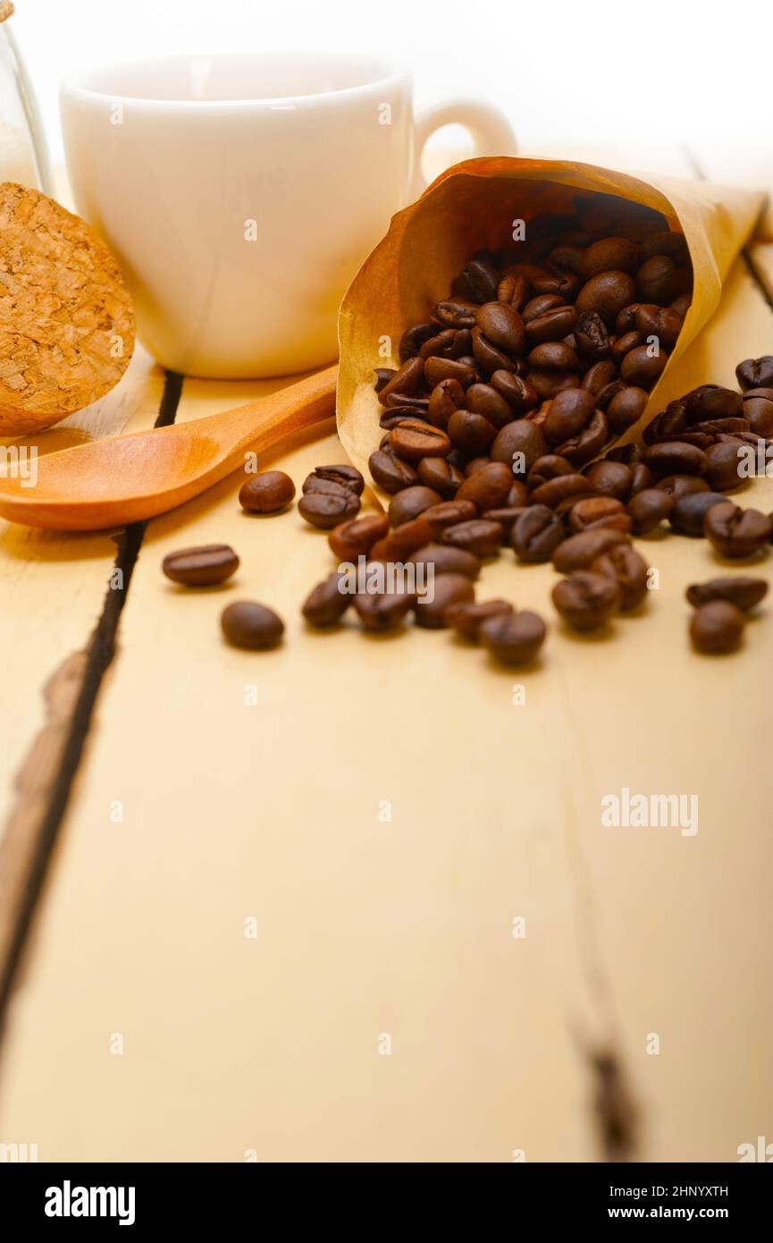 espresso coffee and beans on a paper cone cornucopia over white ...