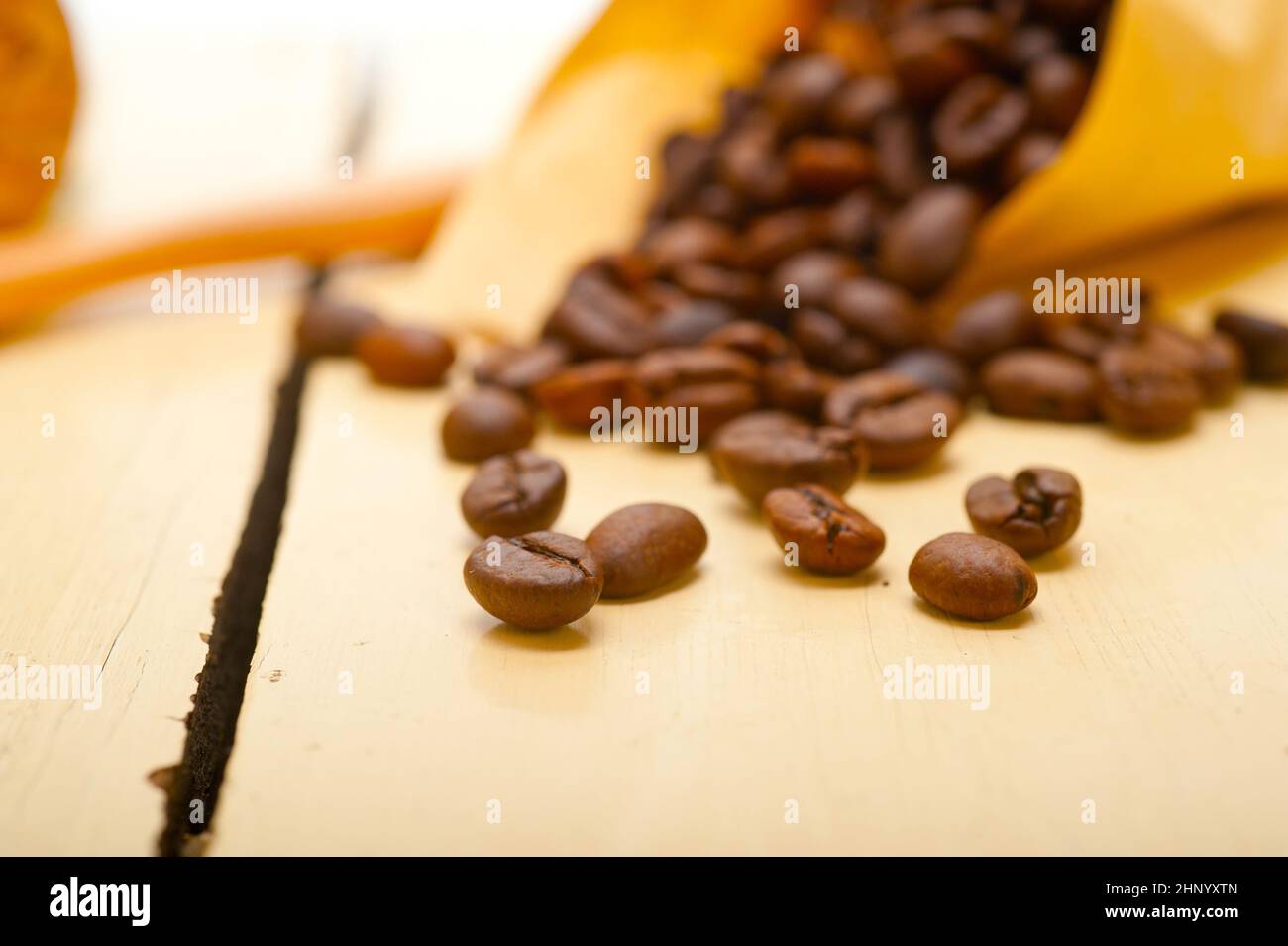 espresso coffee beans on a paper cone cornucopia over white background ...