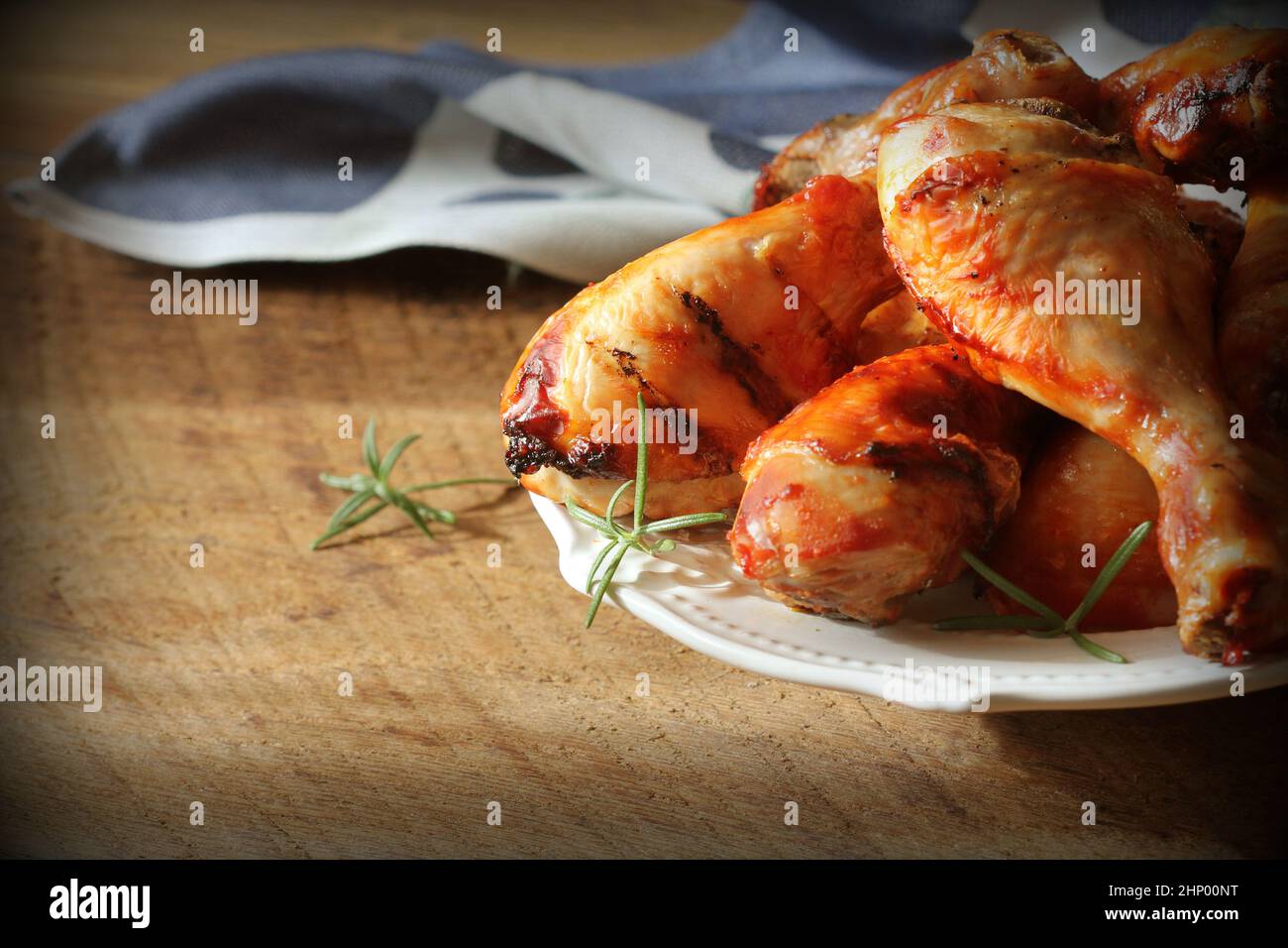 Grilled chicken legs on white plate .Rustic dinner background Stock ...
