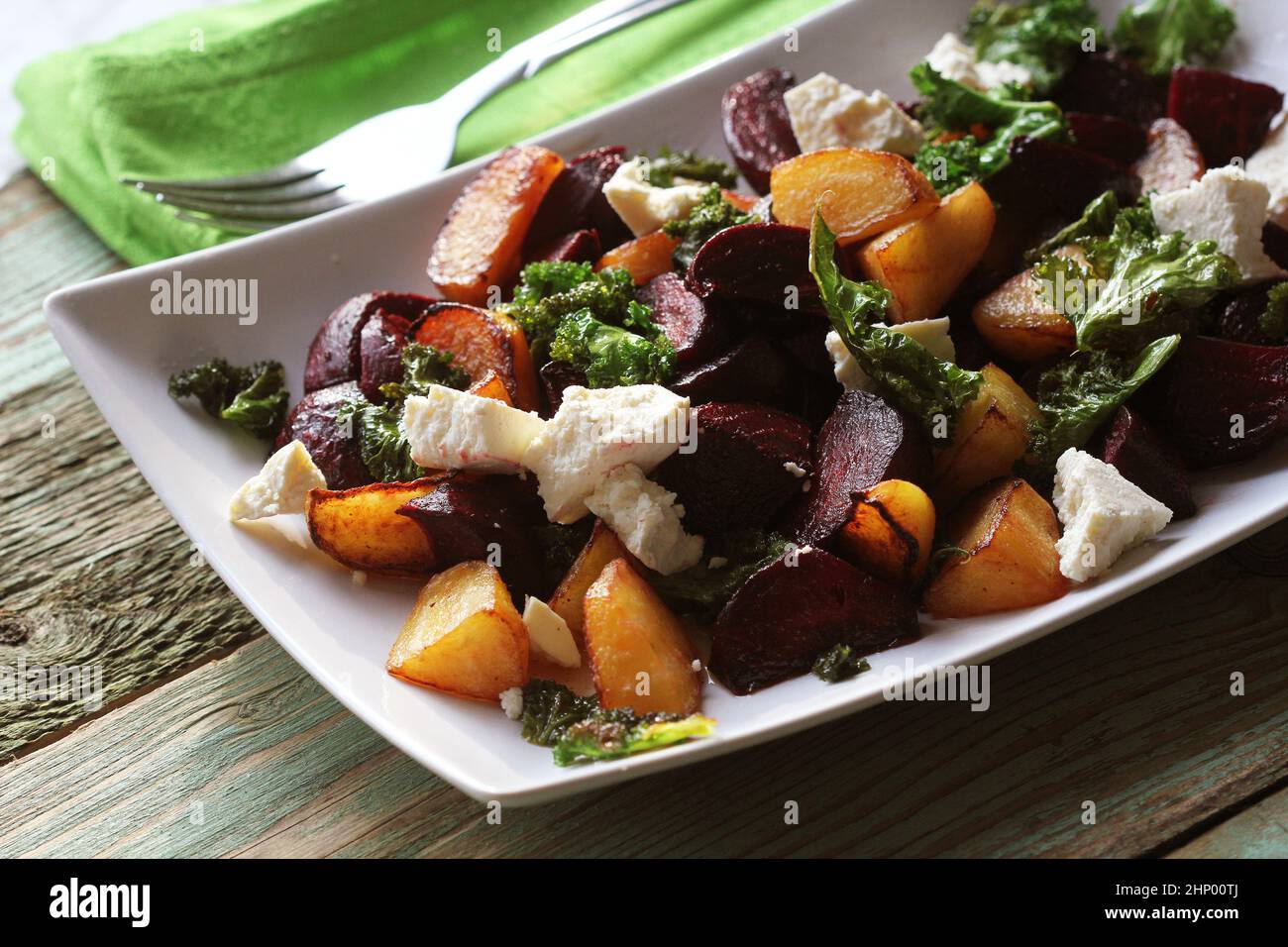 Fresh beet salad with feta cheese and fried cabbage kale Stock Photo ...