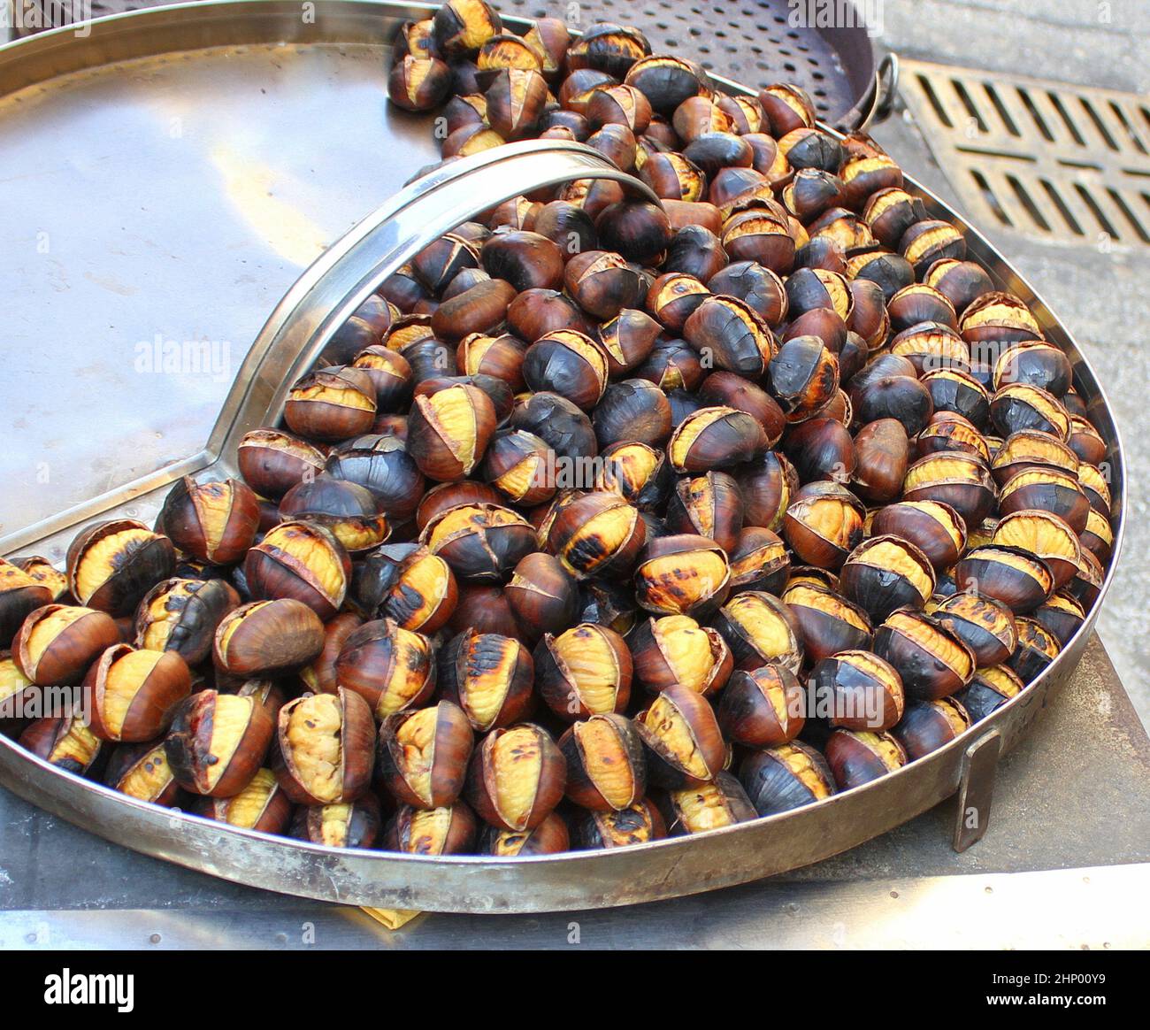 Fried chestnuts on street. Traditional street food in winter fire ...