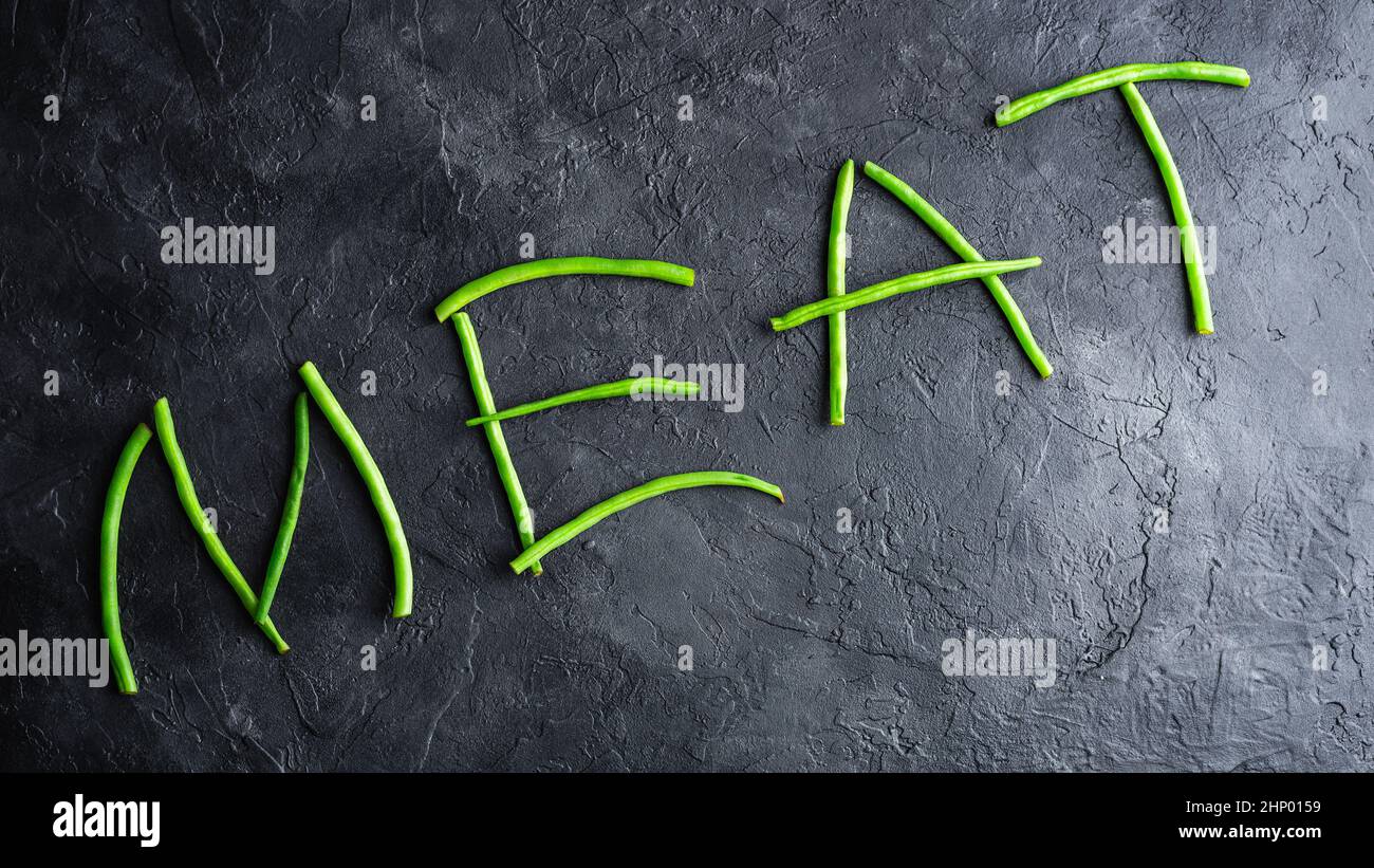 Word Meat Spelled Out In Fresh Pods of Green Beans on Dark Concrete ...