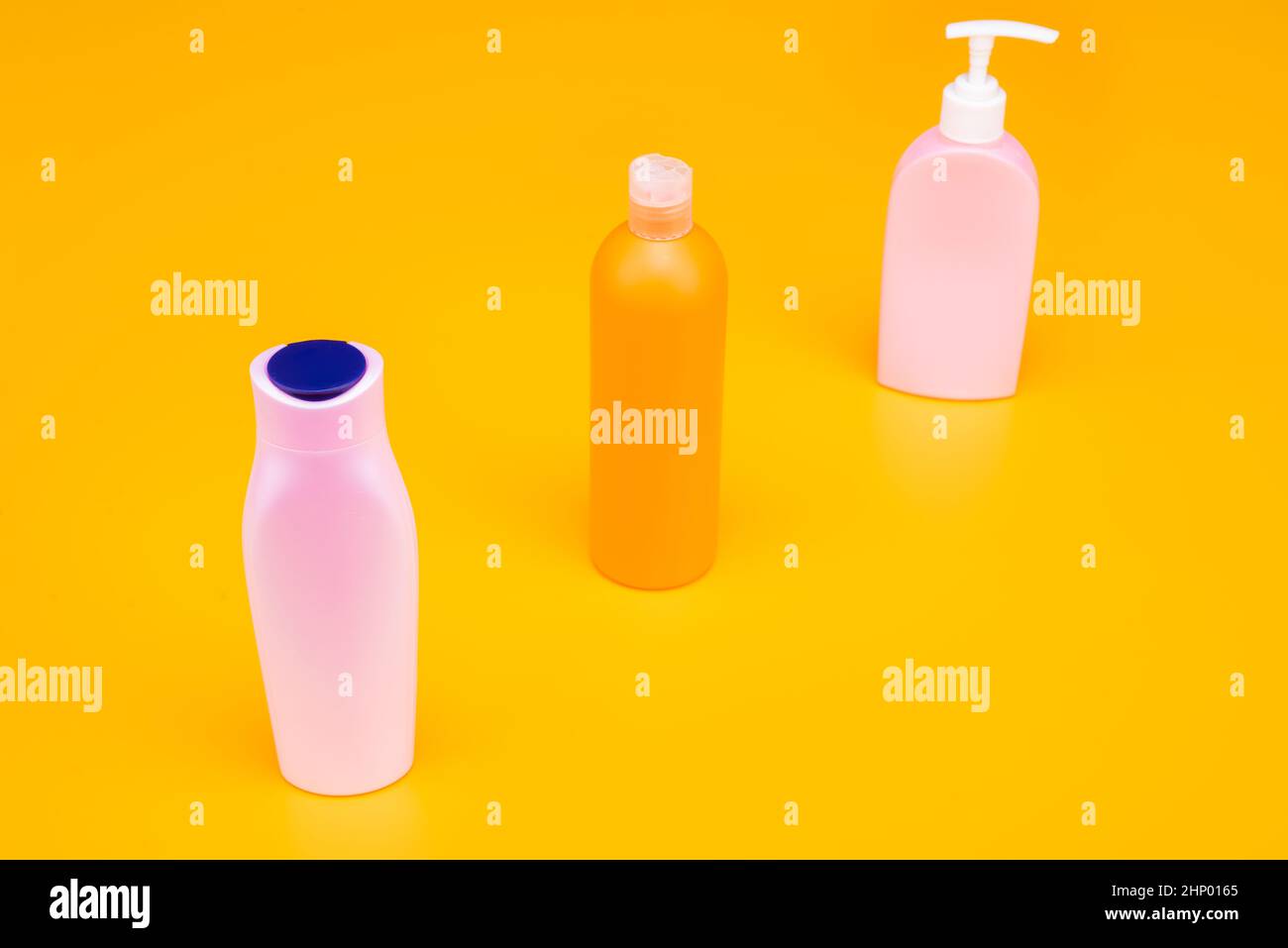 Conveniently shaped containers. Cosmetic bottles in row. Refillable ...