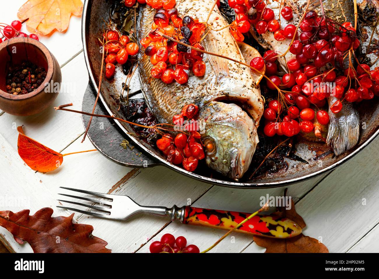 Grilled dorado with autumn berries. Fried fish with viburnum Stock ...