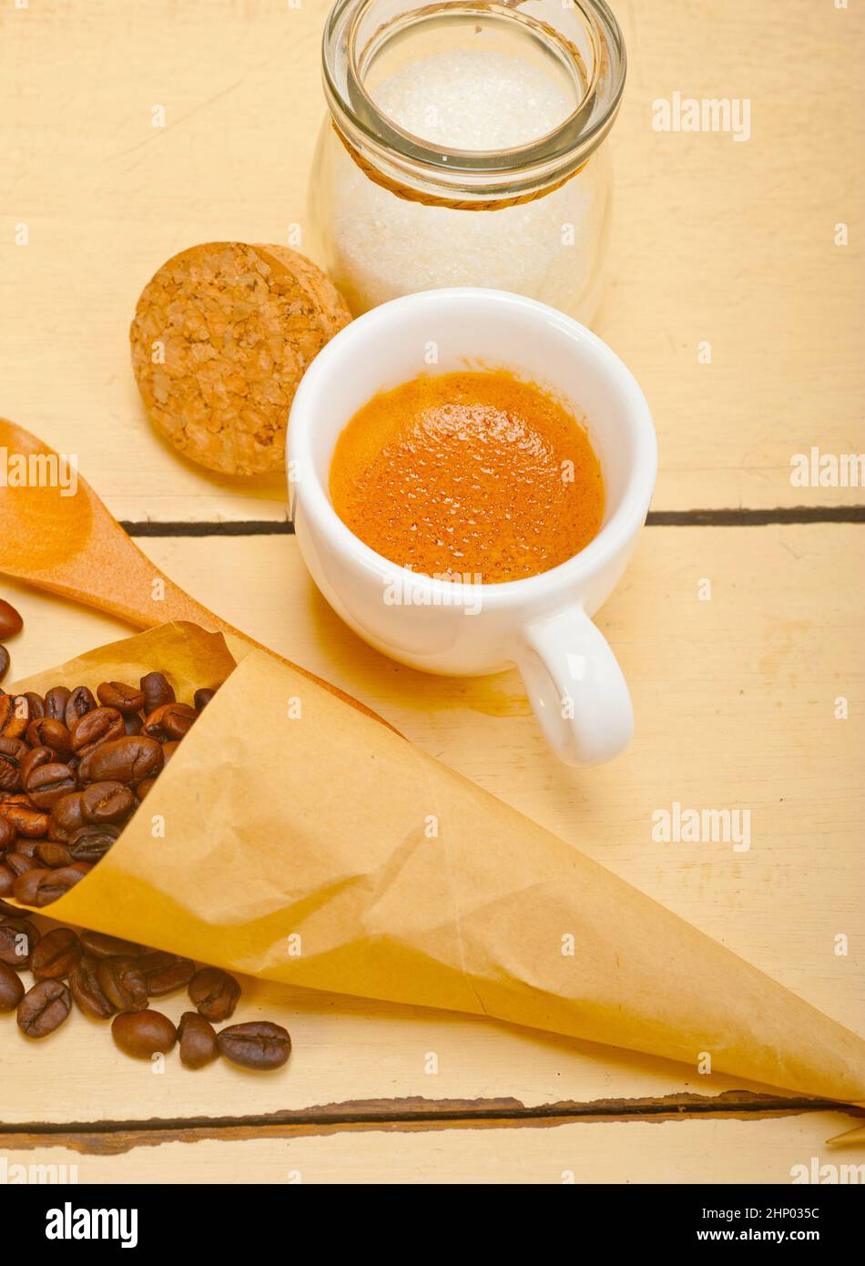 espresso coffee and beans on a paper cone cornucopia over white ...