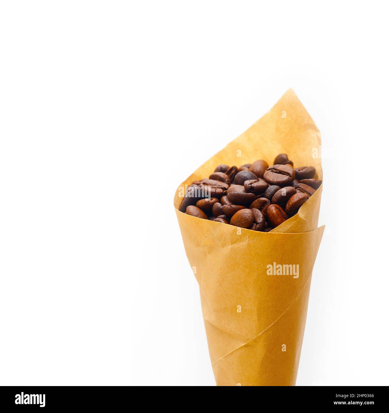 espresso coffee beans on a paper cone cornucopia over white background ...