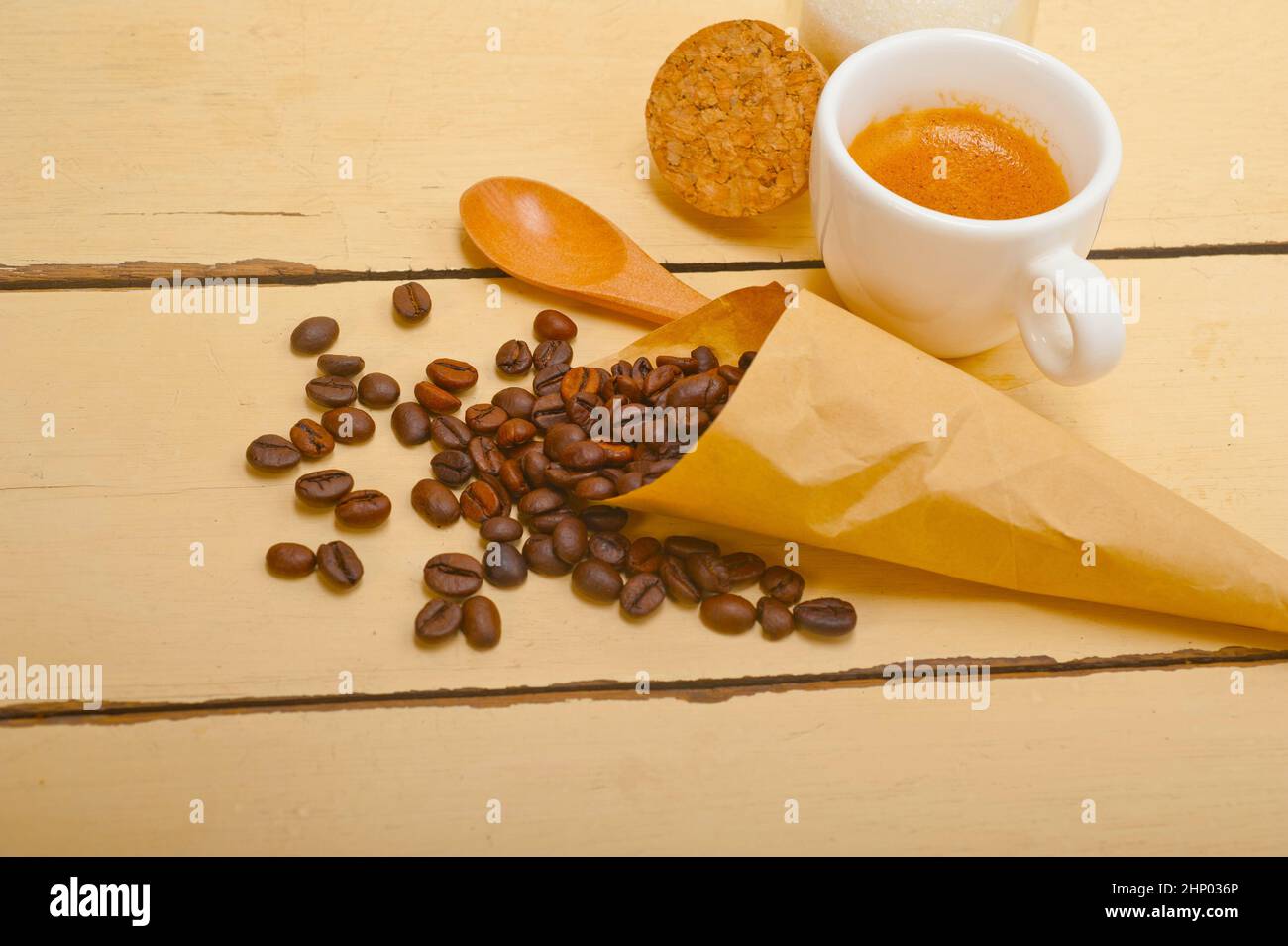 espresso coffee and beans on a paper cone cornucopia over white ...