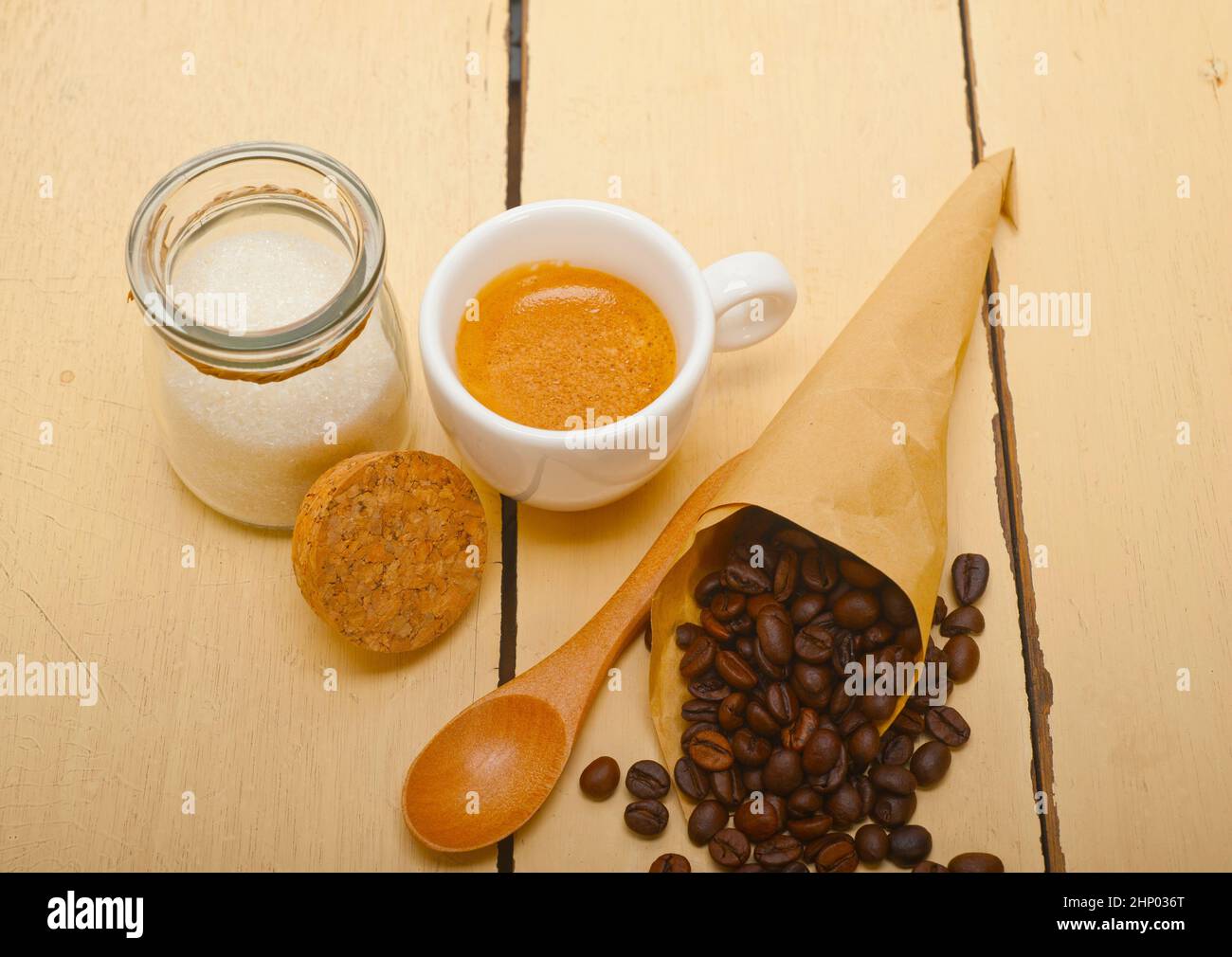 espresso coffee and beans on a paper cone cornucopia over white ...