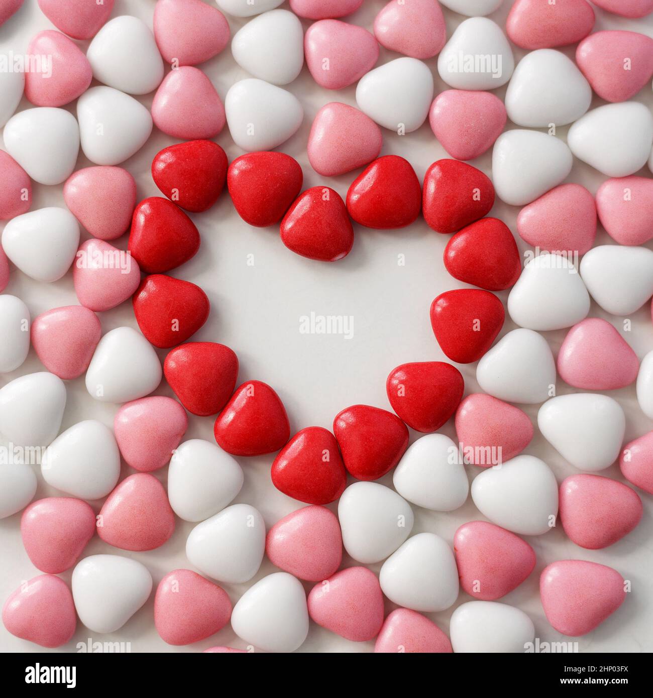 love and sweets - frame of colorful candies in the shape of a heart ...