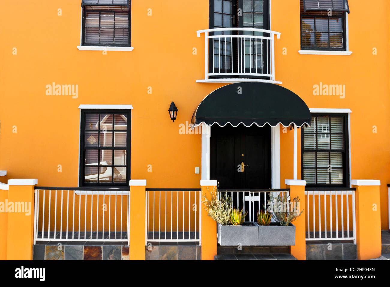Beautiful African orange house with windows and door texture in Bo-Kaap ...