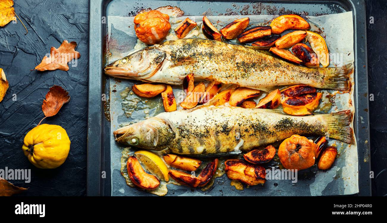 Fish pike perch grilled with quince on baking dish Stock Photo - Alamy