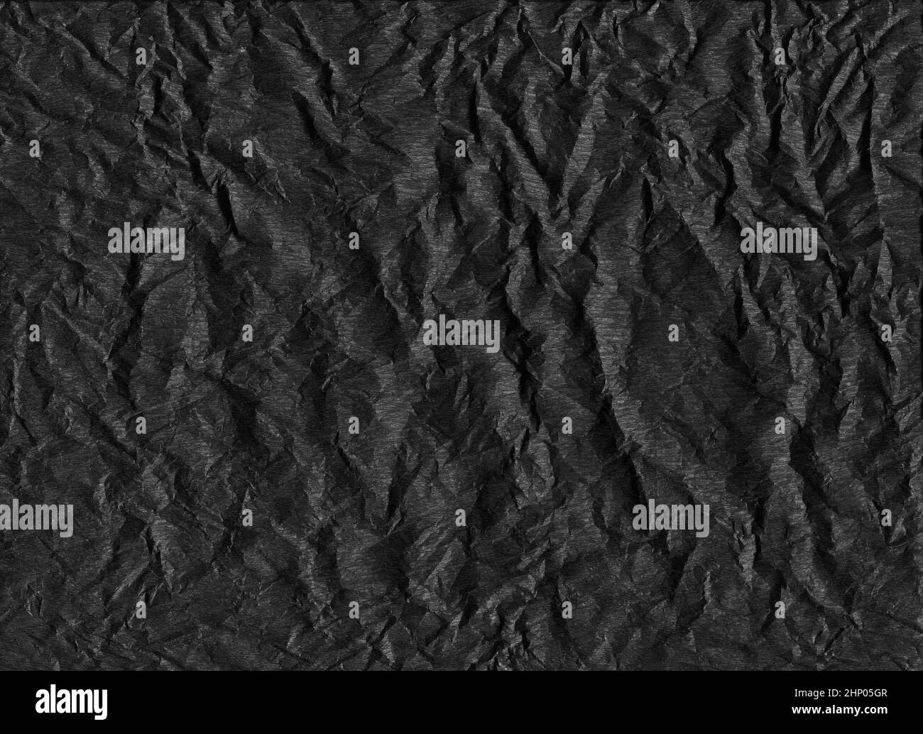horizontal front view of crumpled dark black paper texture with heavy ...