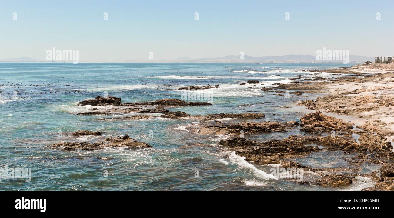 Strong waves, stones and sea cliffs, Sea Point promenade in Cape Town ...