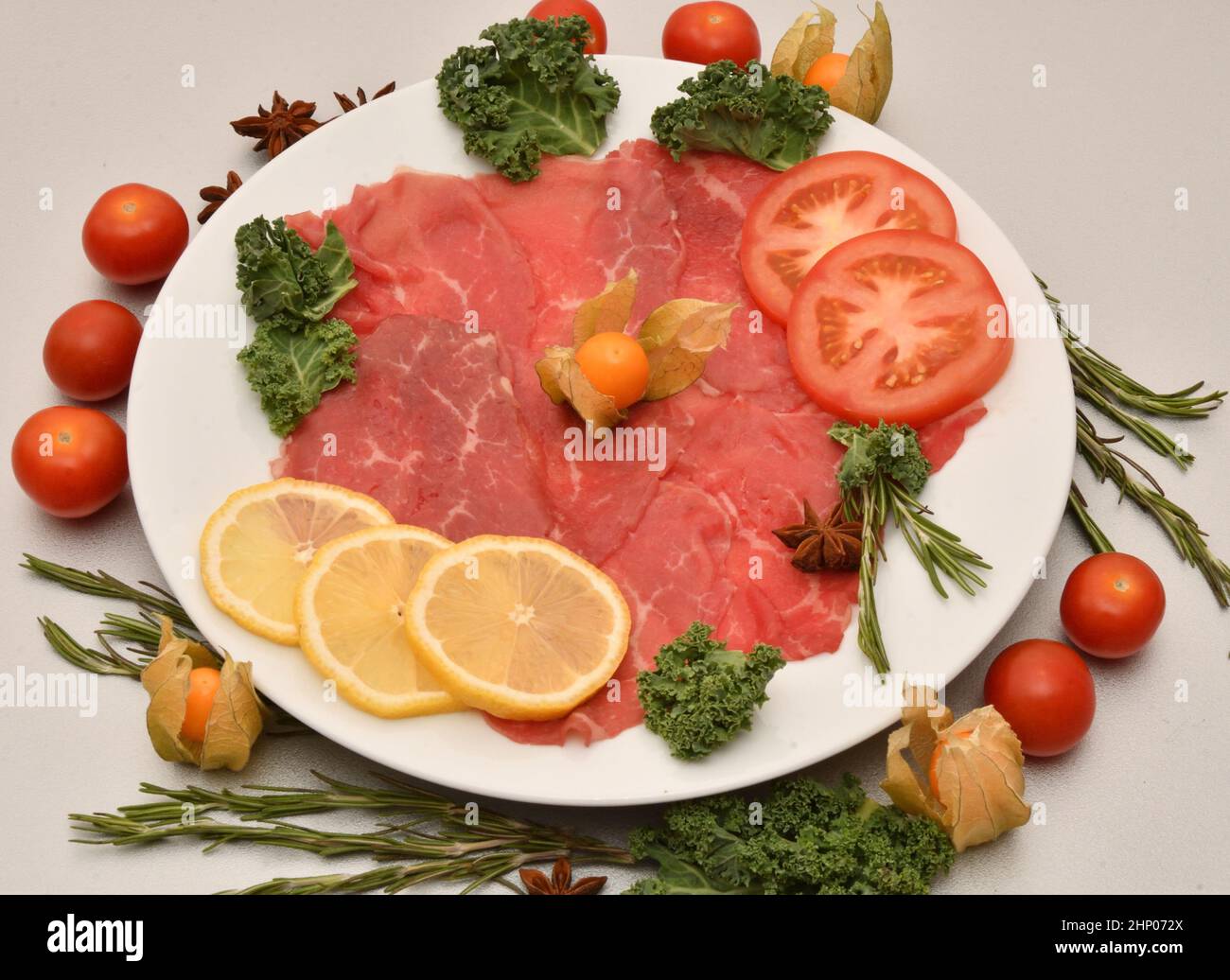 Carpaccio dish of thinly sliced pieces (slices) raw beef tenderloin ...