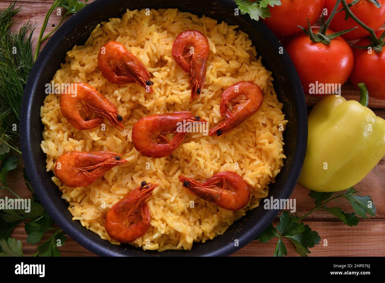 Rice paella with shrimp, saffron and olive oil - Spanish national dish ...