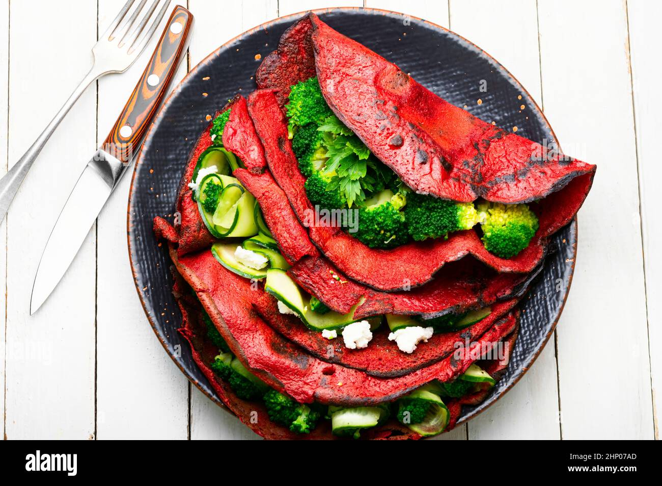 Beetroot pancakes with feta cheese, broccoli and cucumber Stock Photo ...