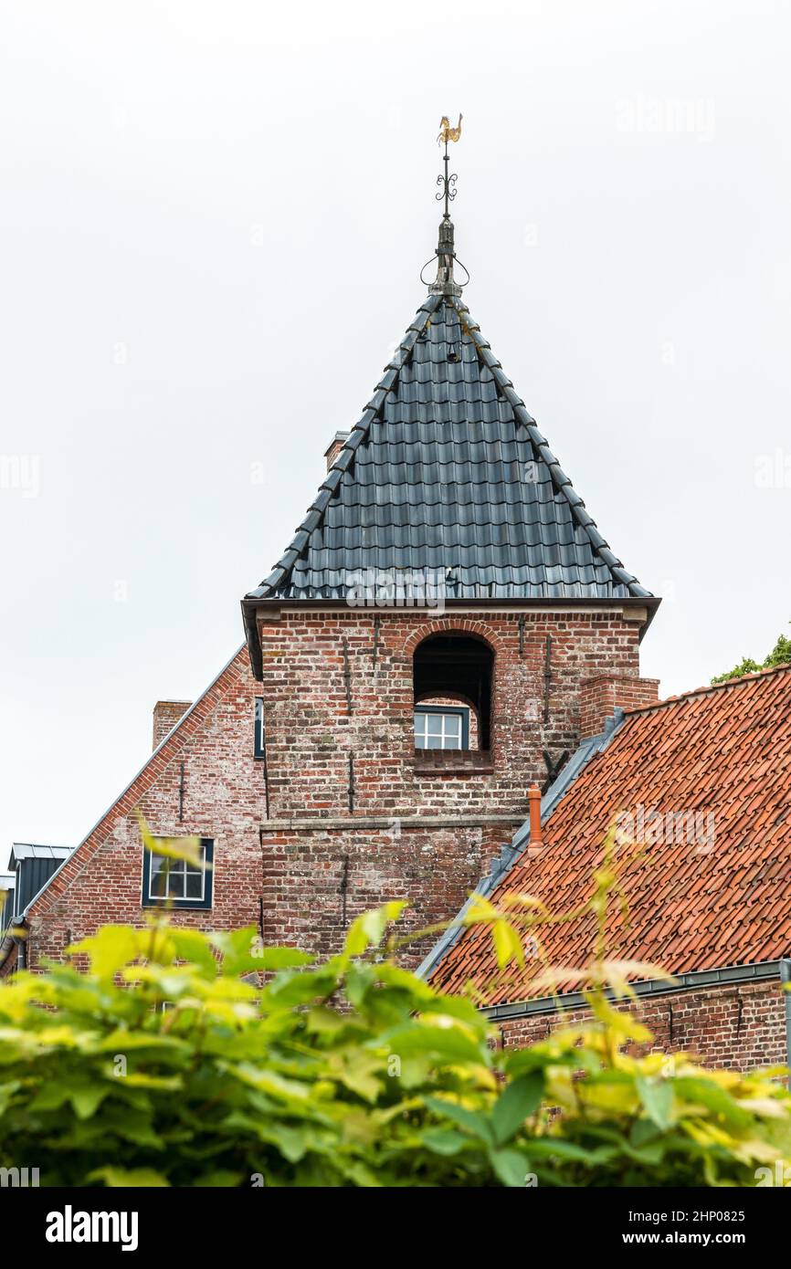 The church, the tower and the bush in front of it Stock Photo - Alamy
