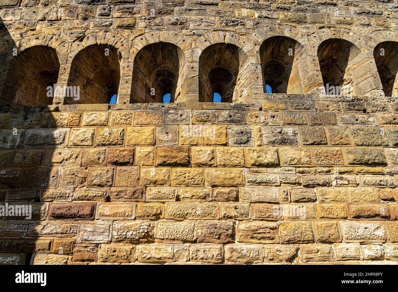Windows inside of the massive high walls of an old medieval castle ...