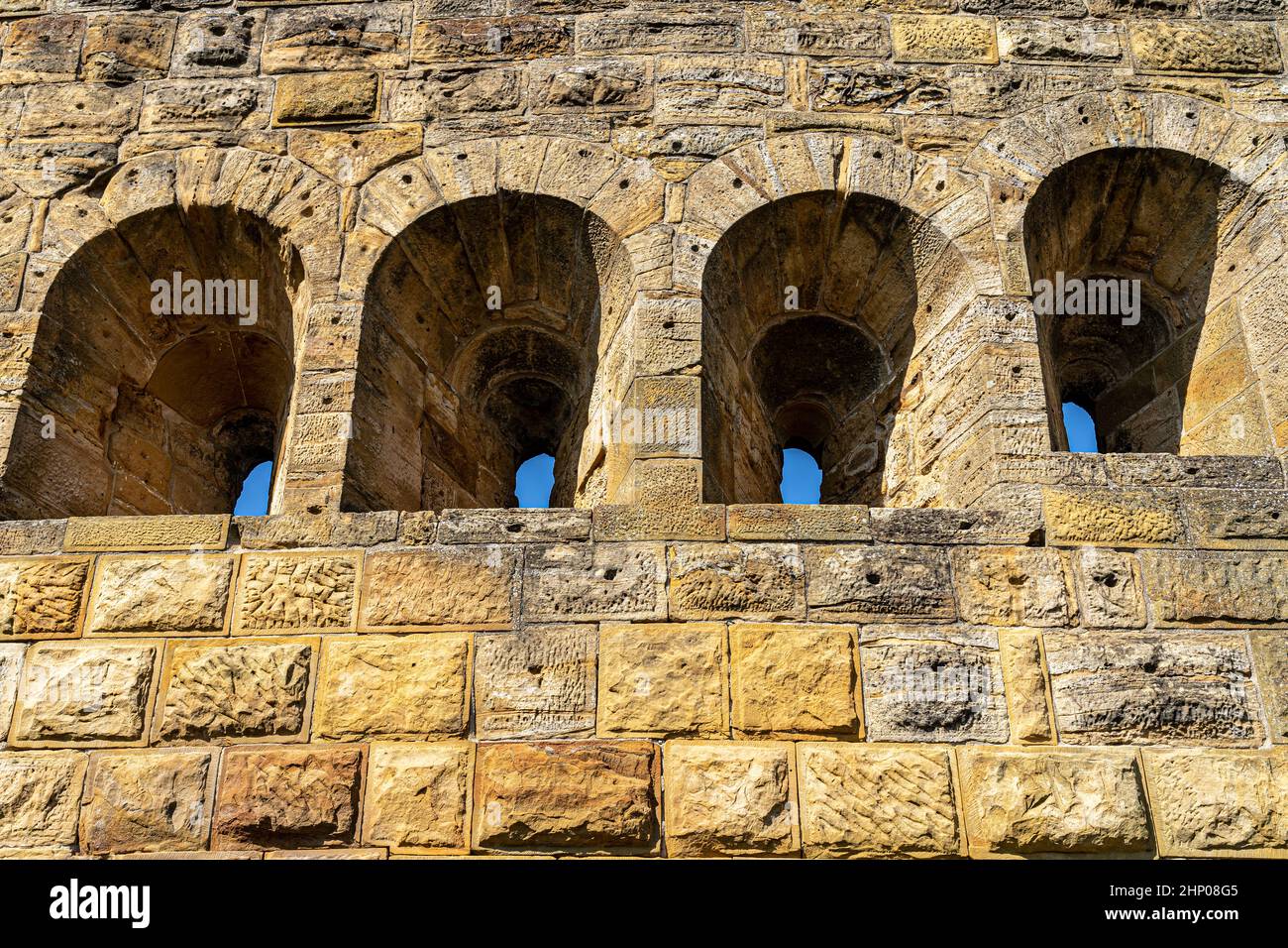 Windows inside of the massive high walls of an old medieval castle ...