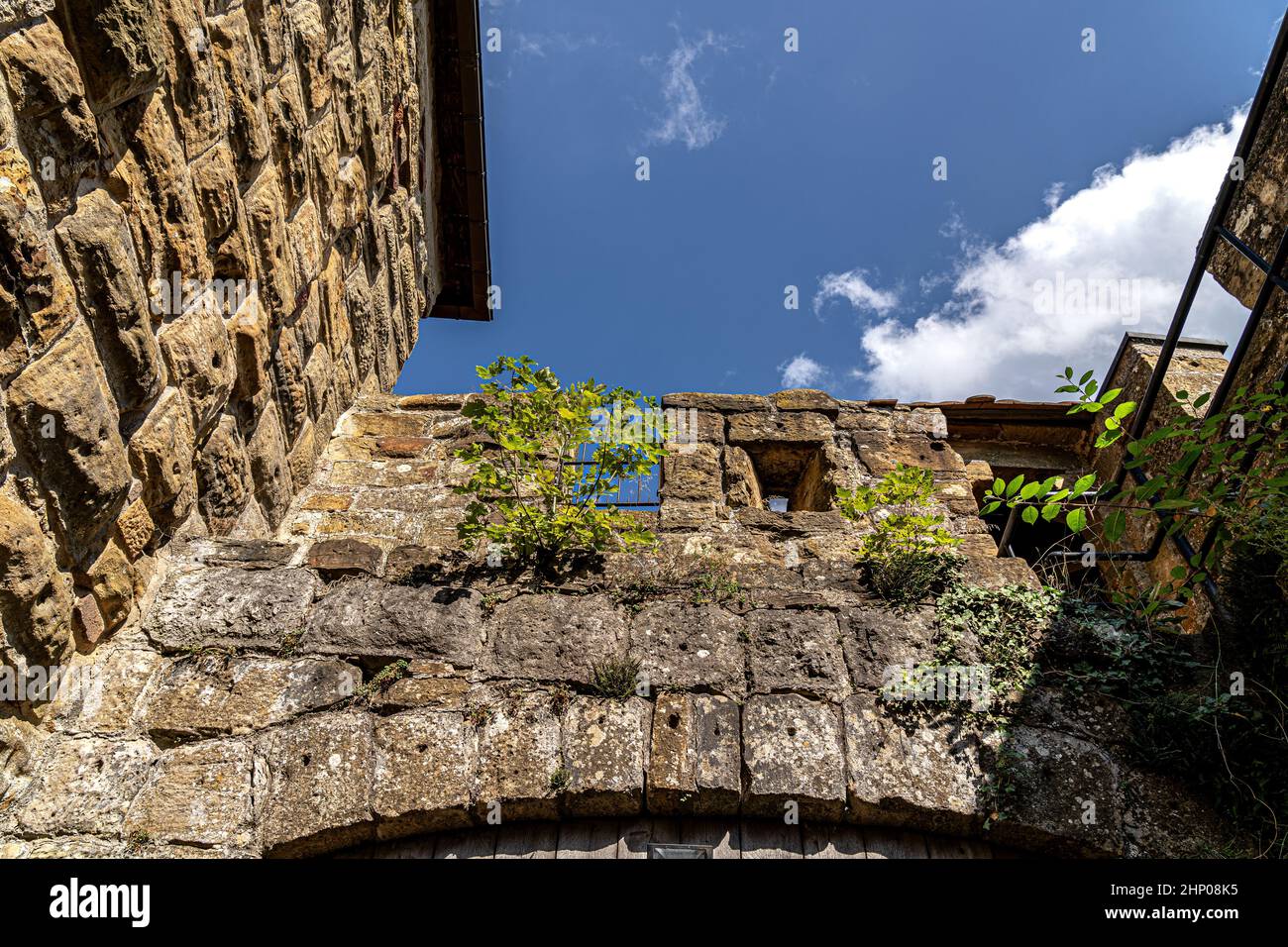 Windows inside of the massive high walls of an old medieval castle ...