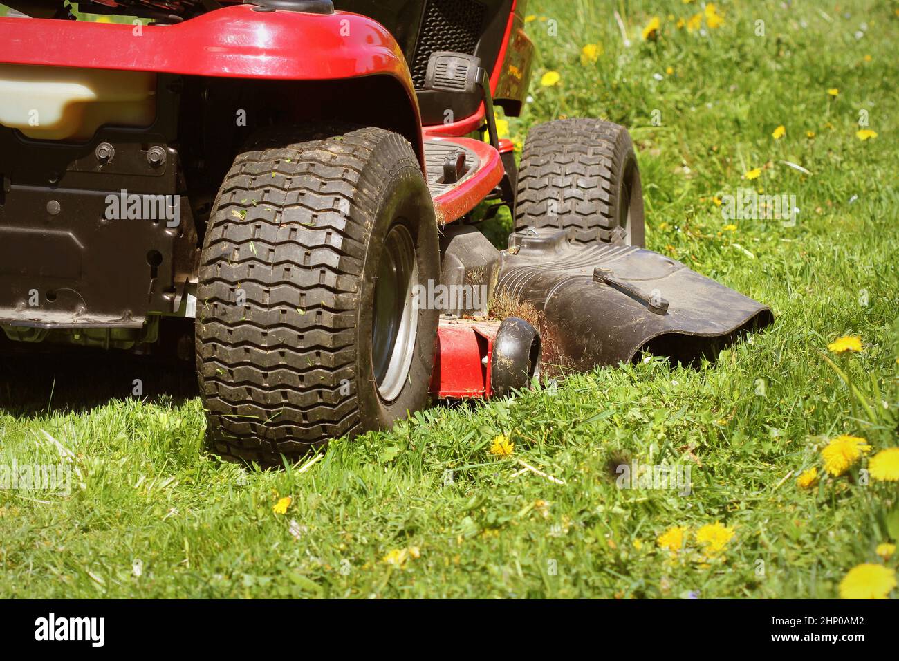 cutting the grass of on a tractor lawn mower Stock Photo - Alamy
