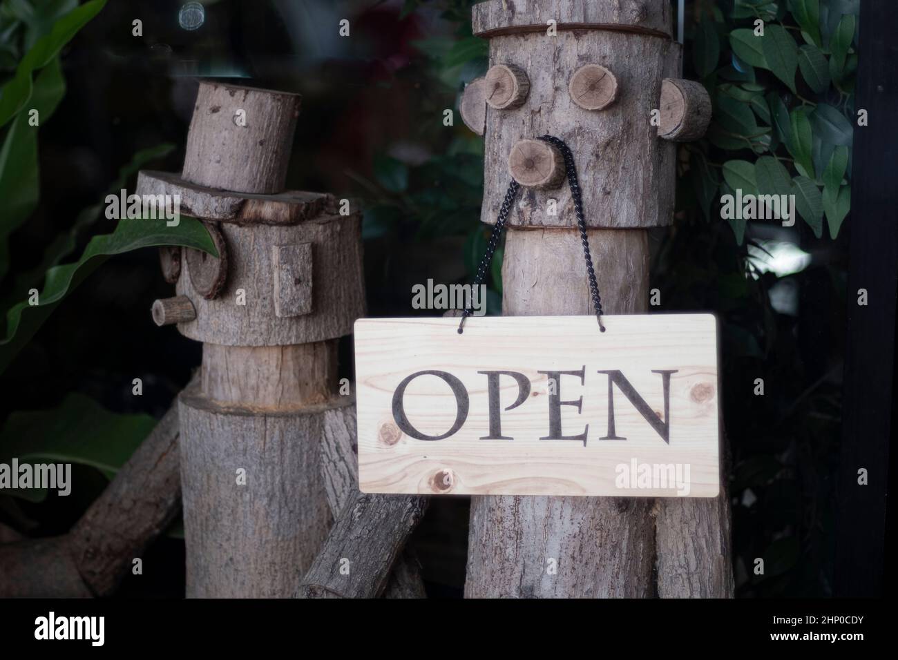 Open Sign Hanging on wooden doll in front of entrance door for ...