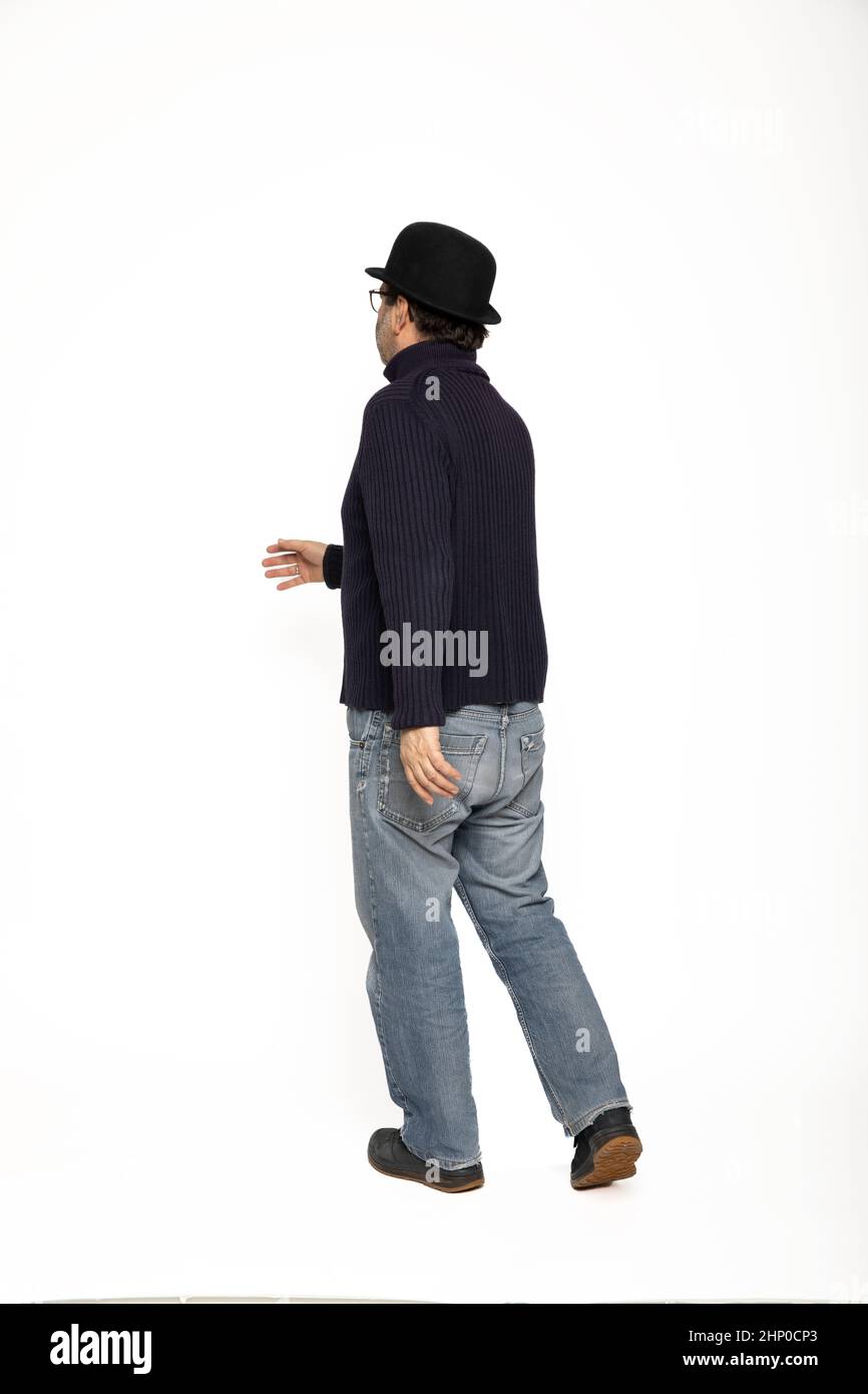 Three-quarter man walks to the left. He is wearing a blue sweater ...