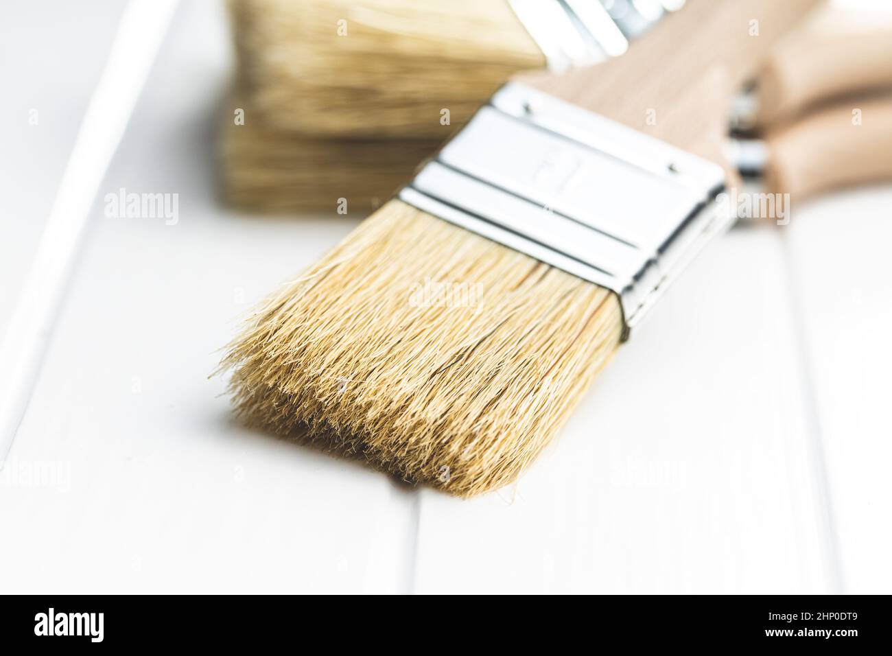 Set of clean paint brushes on white table Stock Photo - Alamy