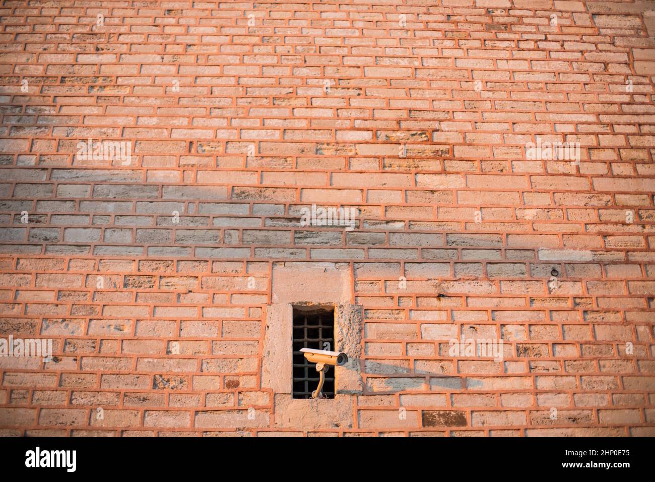 A surveillance camera on a brick wall Stock Photo - Alamy