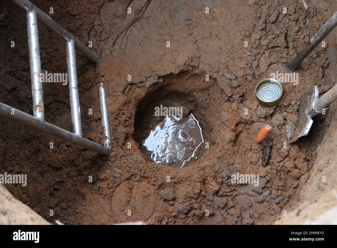 groundwater has appeared at the bottom of a deep round well with hand ...