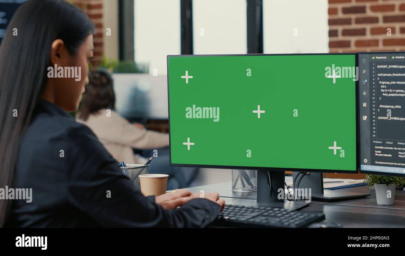 Focus on computer screen with green screen chroma key mockup in front ... Focus on computer screen with green screen chroma key mockup in front ...