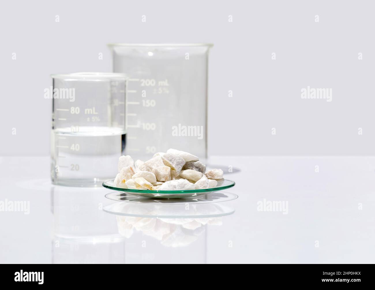 Calcium carbonate Chip in Chemical Watch Glass place next to crystal ...