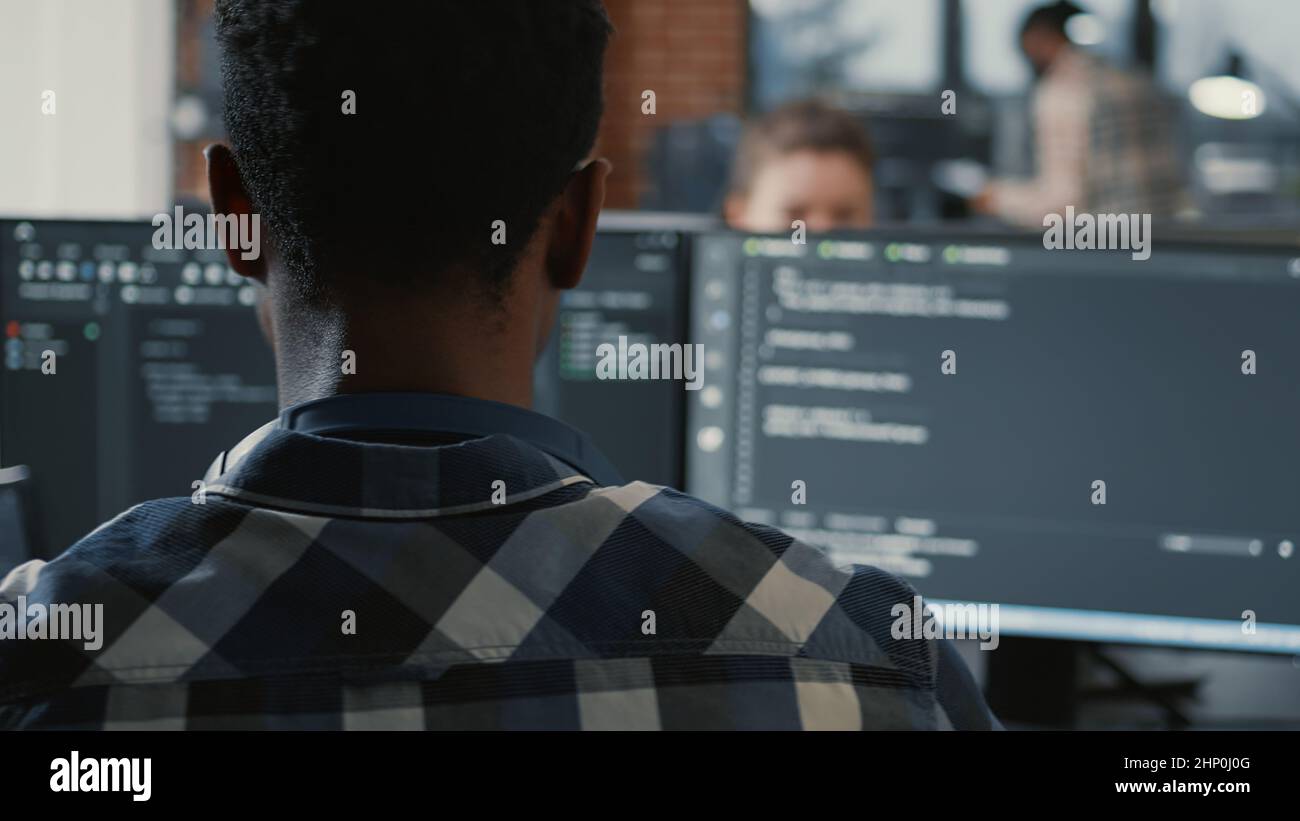 Programer sitting desk multiple screens hi-res stock photography and ...