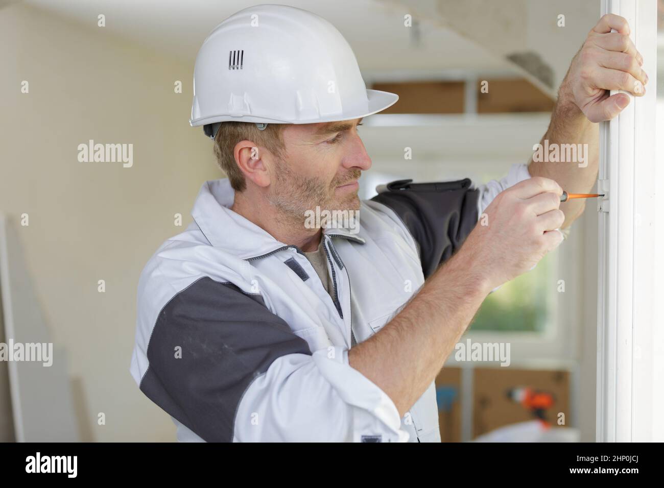 Young man fixing door hi-res stock photography and images - Alamy
