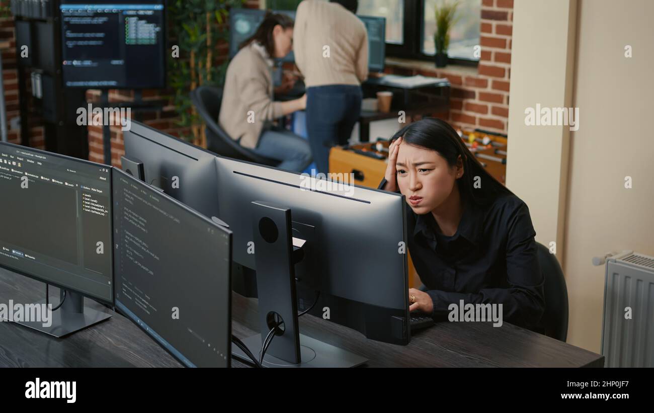 Portrait Of Asian Programer Focused On Writing Code Encounters Unexpected Compiling Error