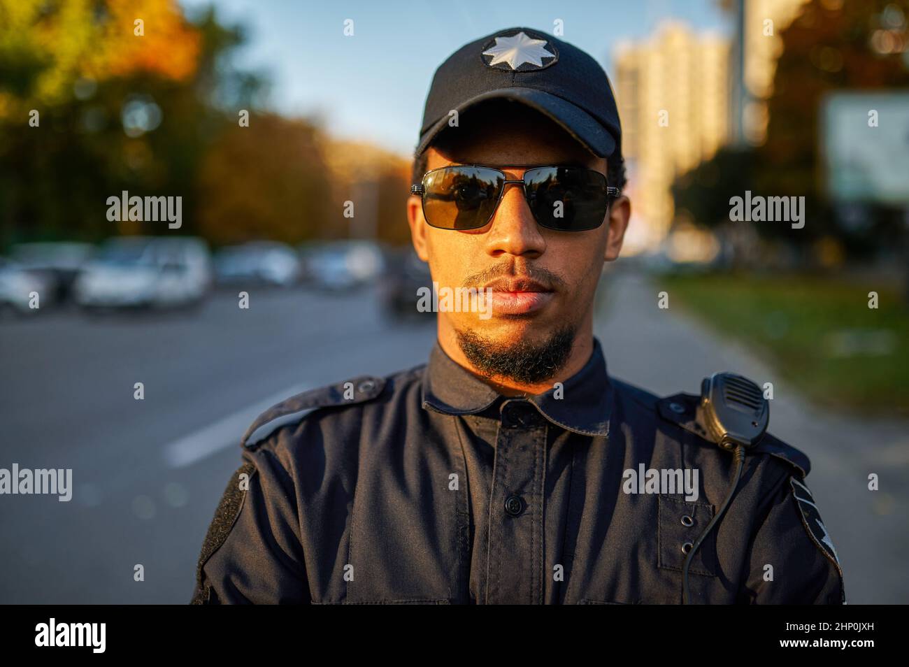 Male police officer in uniform and sunglasses outdoors. Policeman ...