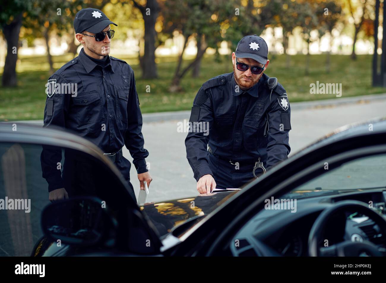 Two male police officers arrest female suspect. Policemen in uniform ...
