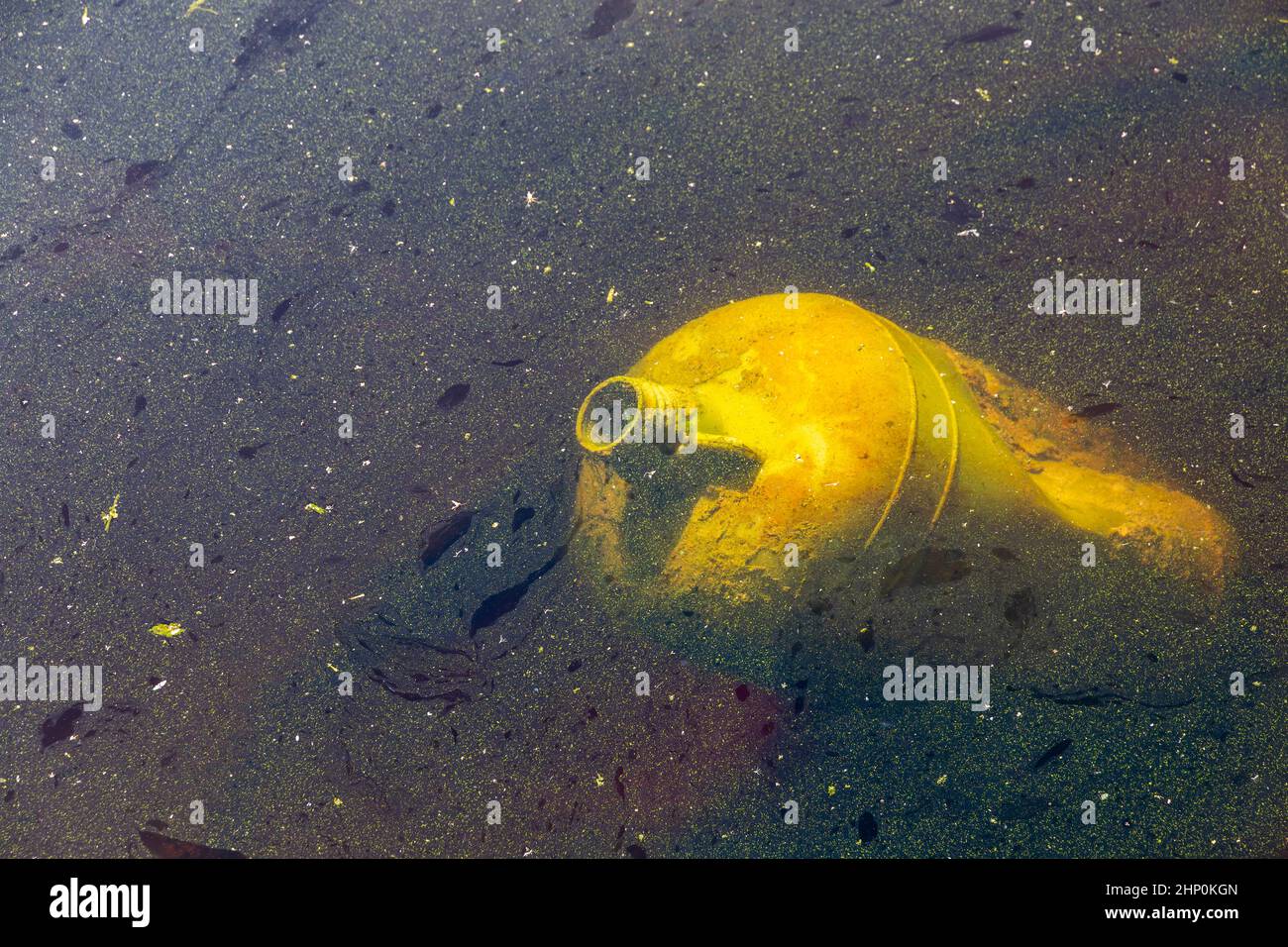 Plastic container submerged under the waters of a river with obvious ...