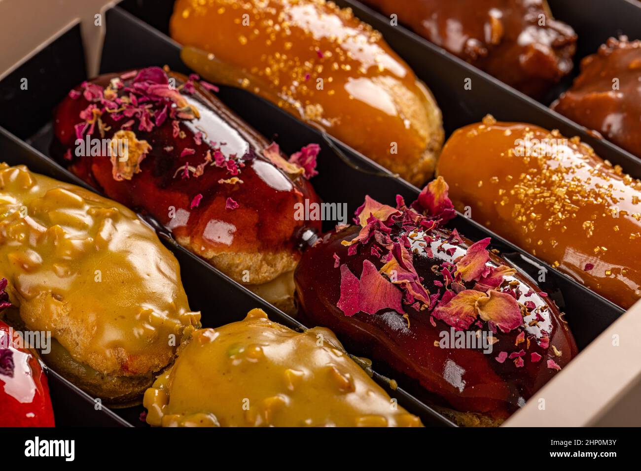 Set of assorted mini eclairs with custard, ready for sale Stock Photo ...