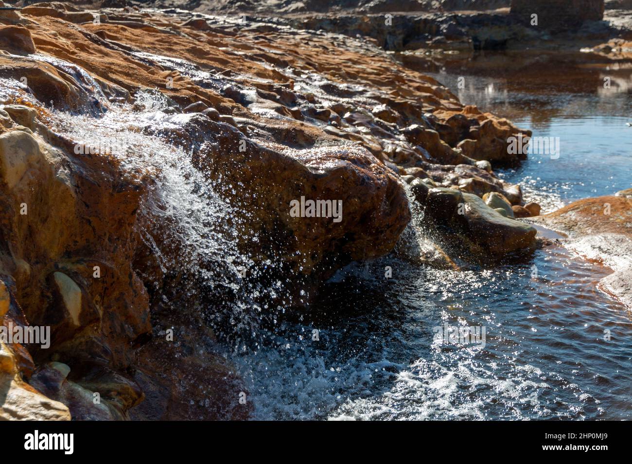 Small waterfalls formed by water running over rocks in the Rio Tinto ...
