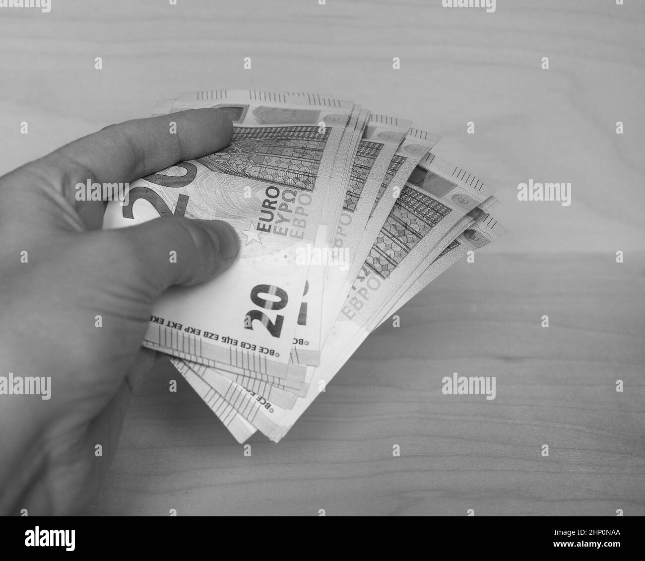 Hand holding Euro banknotes money (EUR), currency of European Union in ...