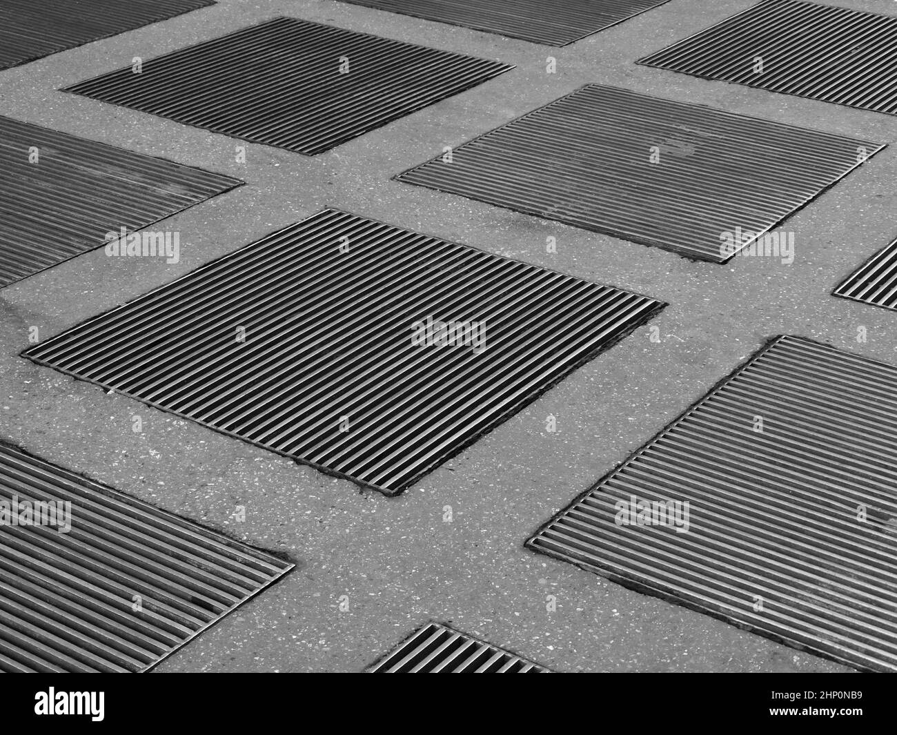 manhole cover grid useful as an industrial background Stock Photo - Alamy