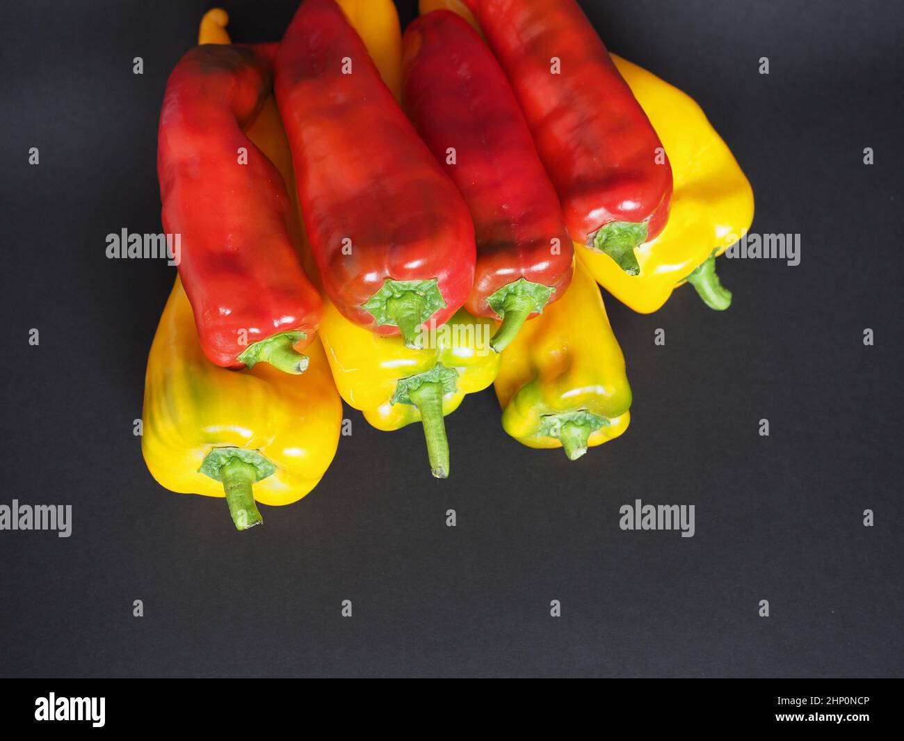 red and yellow peppers (scientific name Capsicum aka bell peppers ...