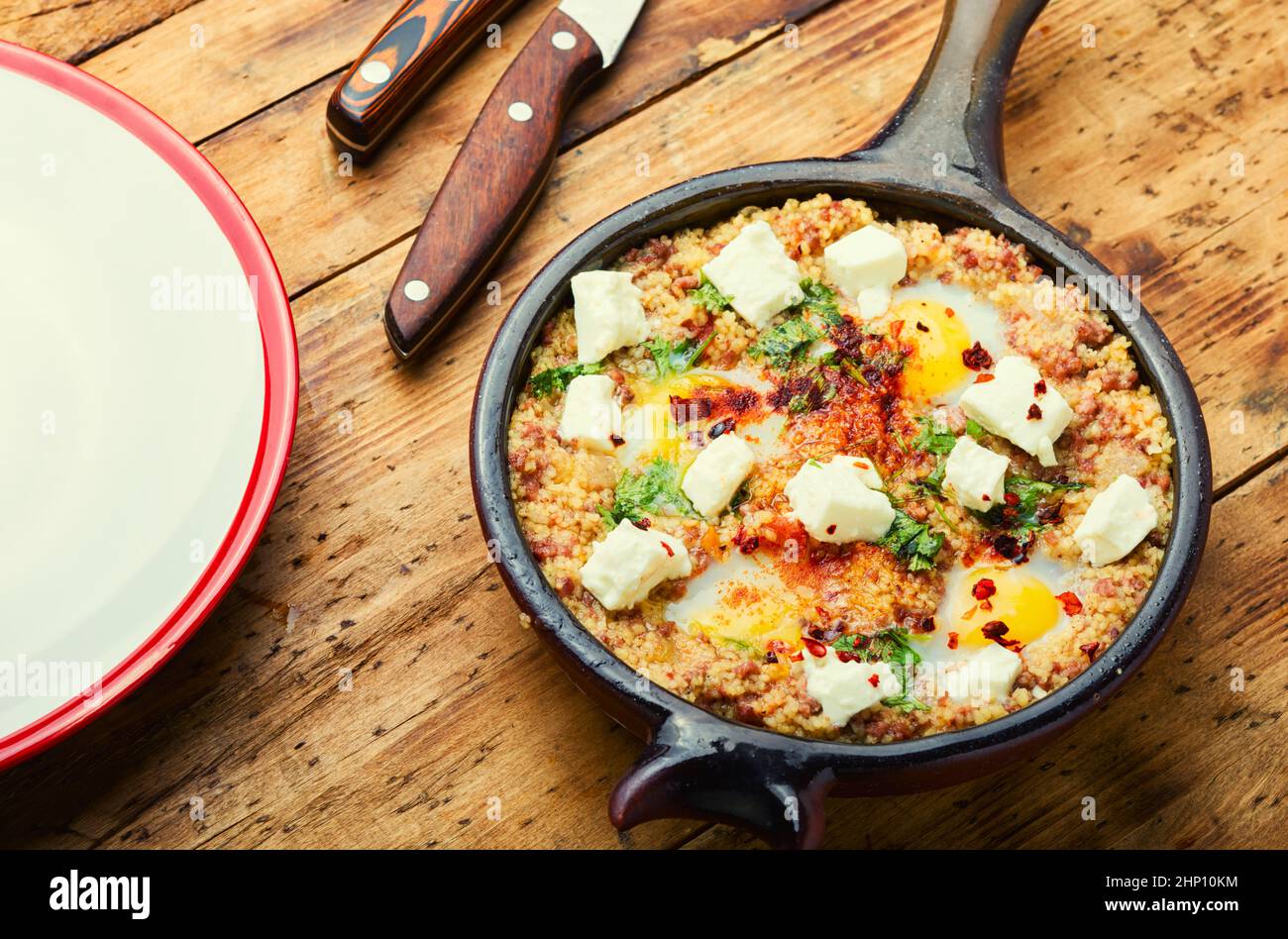 Israeli shakshuka made from fried eggs, tomato, minced lamb and hot ...