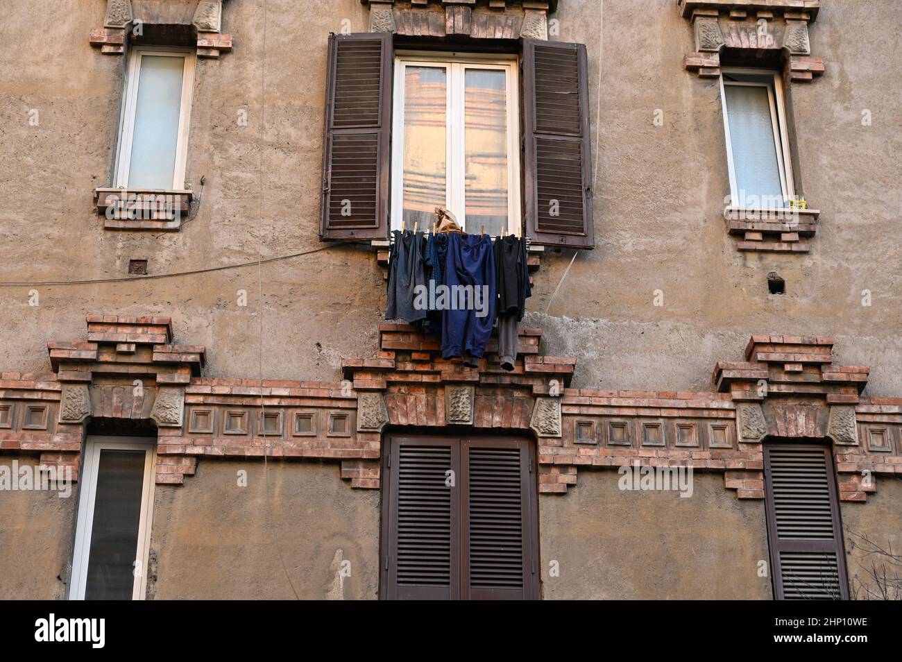 A typical old Italian house with a clothesline between the windows ...