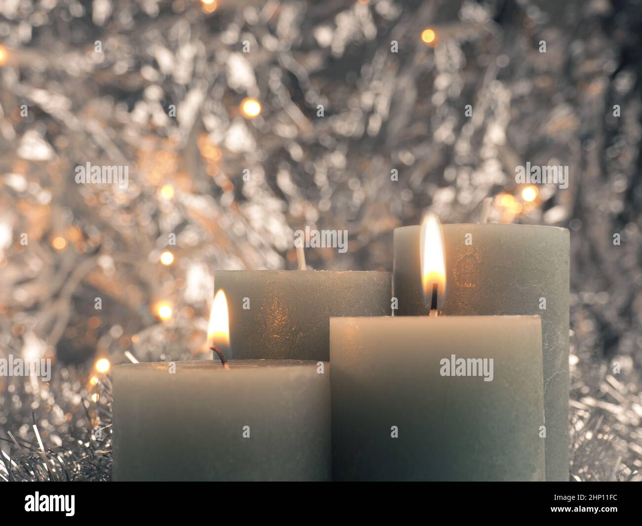 Second Advent candle burns, silver background with text free space ...
