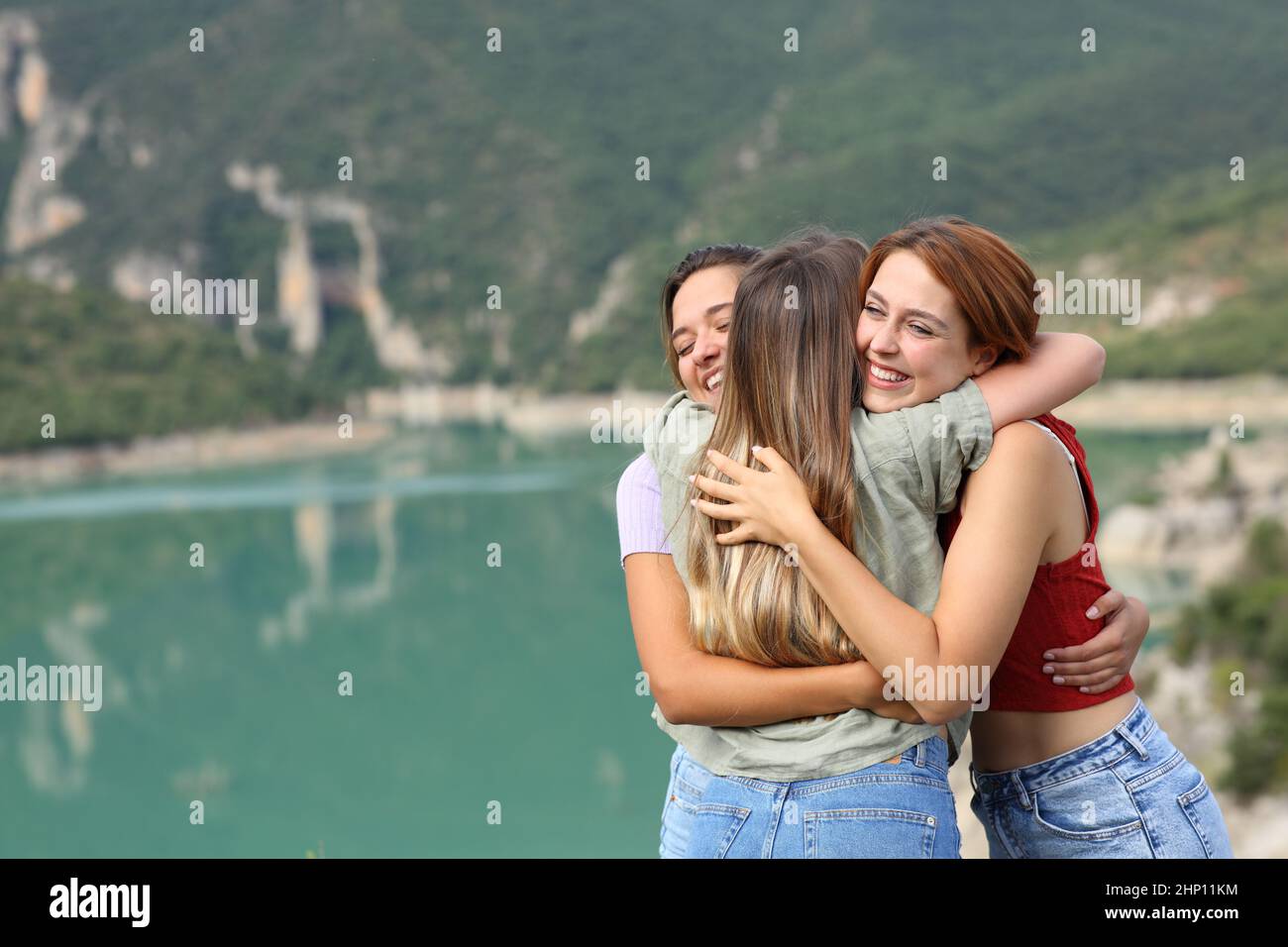 Happy friends hugging and laughing in a lake on summer vacation Stock ...