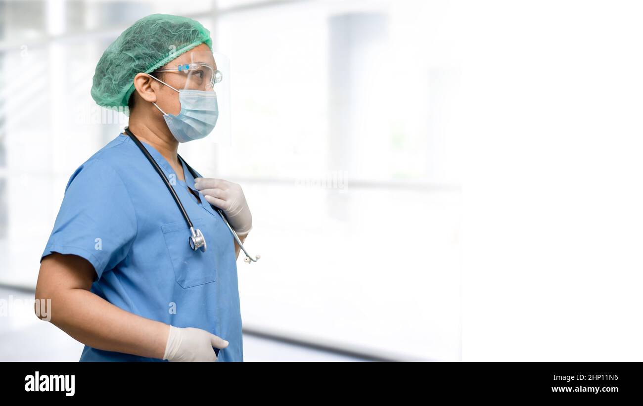 Asian doctor wearing face shield and PPE suit new normal to check ...