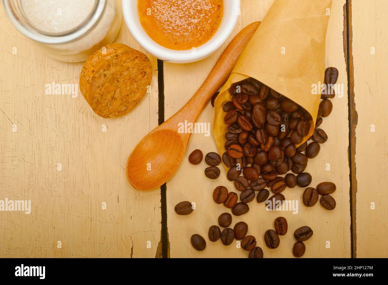 espresso coffee and beans on a paper cone cornucopia over white ...